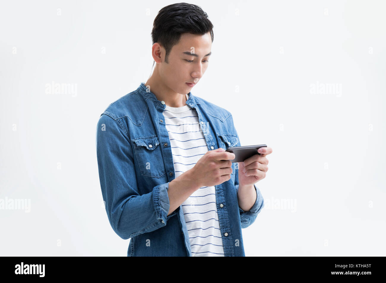 Young man playing mobile games Stock Photo - Alamy
