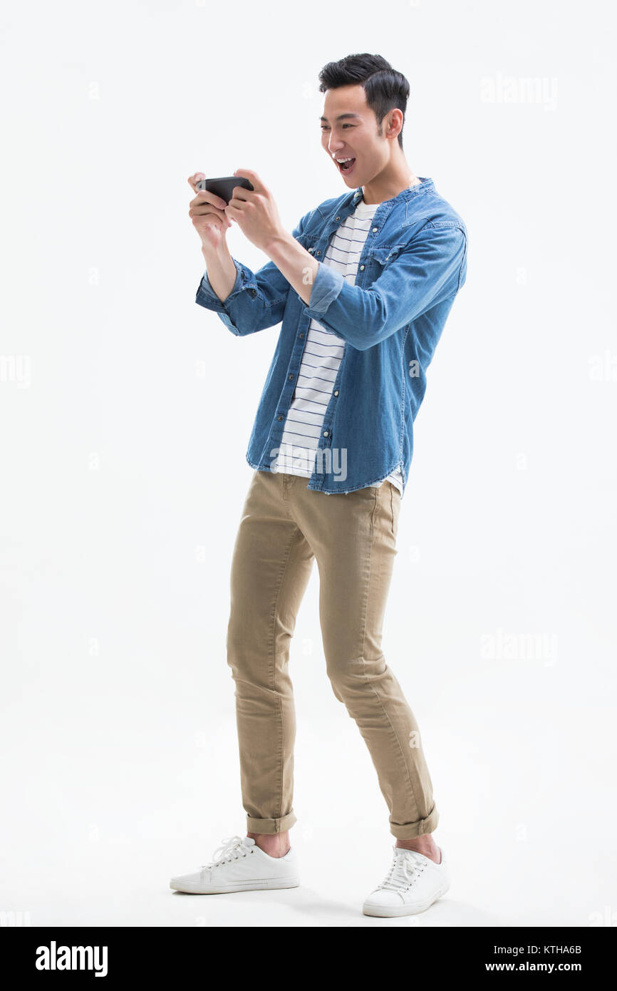 Young man playing mobile games Stock Photo - Alamy
