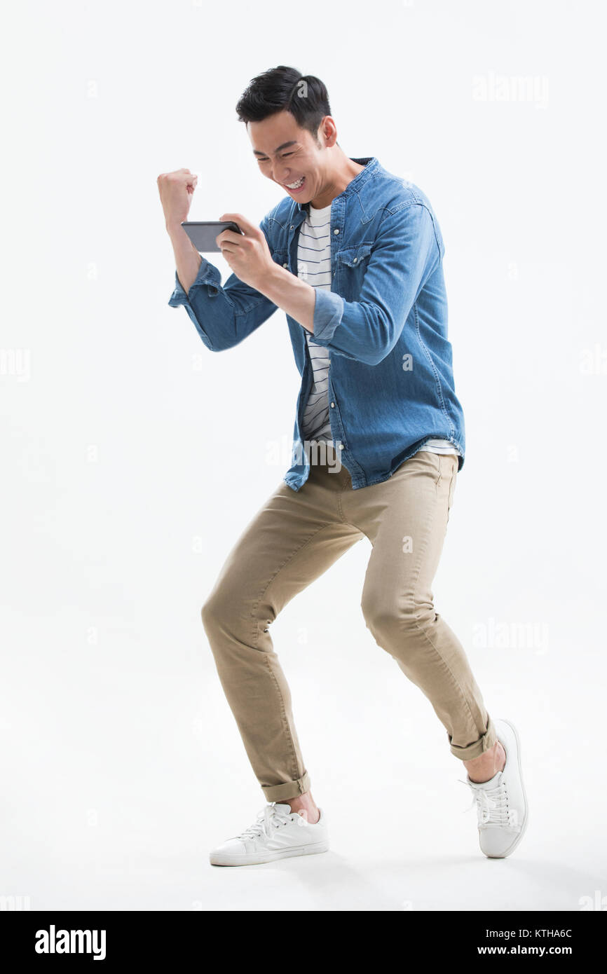 Young man playing mobile games Stock Photo - Alamy