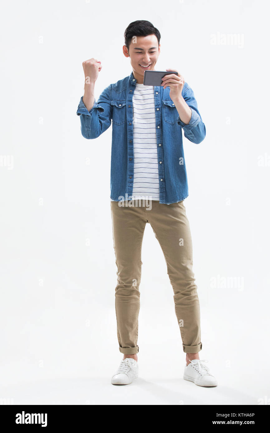 Young man playing mobile games Stock Photo - Alamy