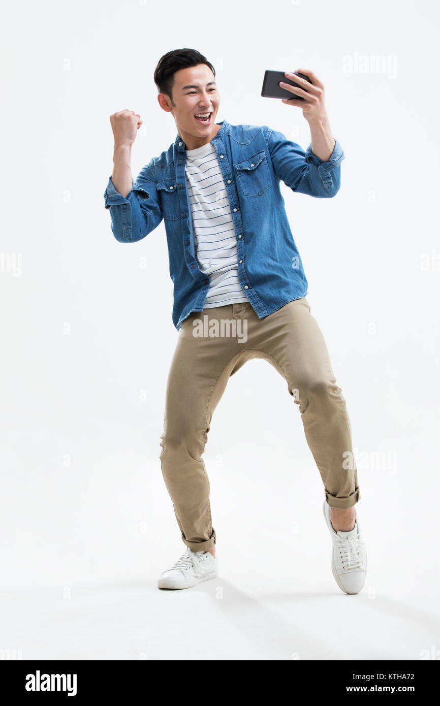 Young man playing mobile games Stock Photo - Alamy