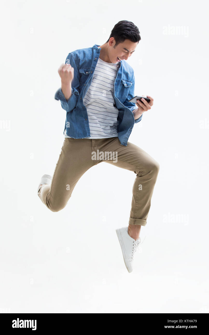 Young man playing mobile games Stock Photo - Alamy