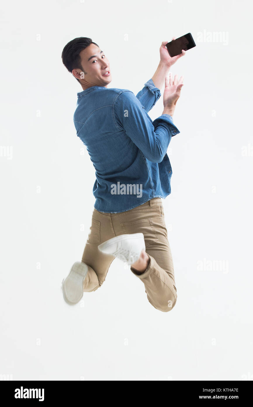 Young man playing mobile games Stock Photo - Alamy