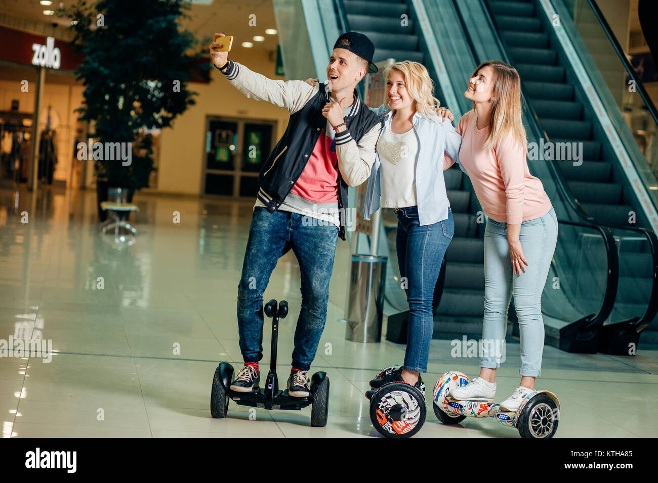 New modern technologies. three people on hoverboard doing selfie Stock ...