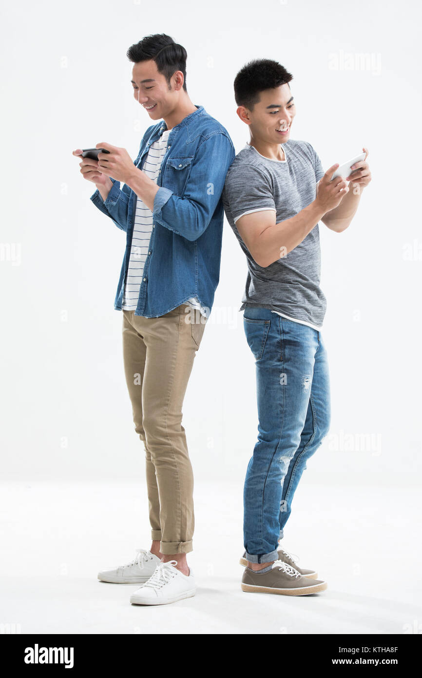 Young men playing mobile games Stock Photo - Alamy