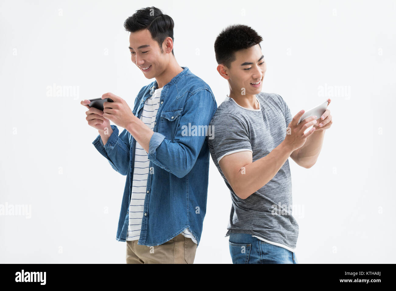 Young men playing mobile games Stock Photo - Alamy