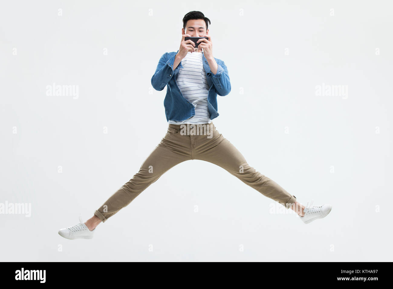 Young man playing mobile games Stock Photo - Alamy