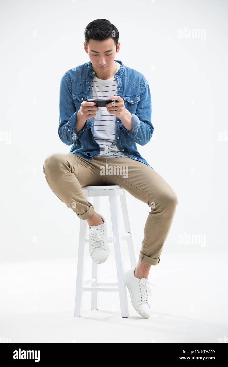 Young man playing mobile games Stock Photo - Alamy