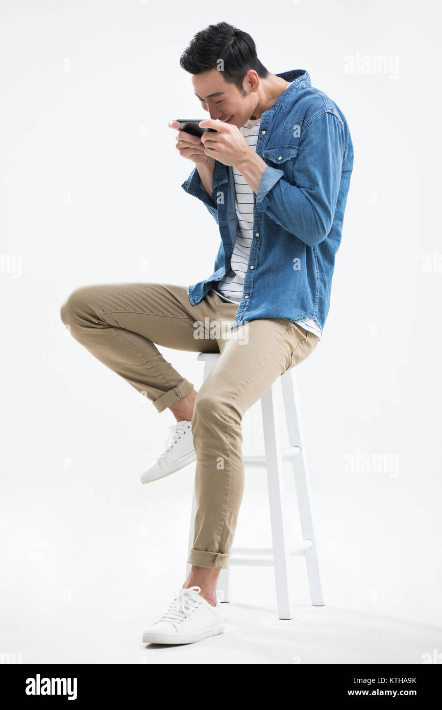 Young man playing mobile games Stock Photo - Alamy