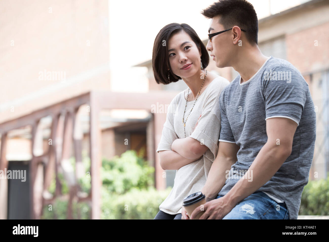 Young couple talking outdoors Stock Photo - Alamy