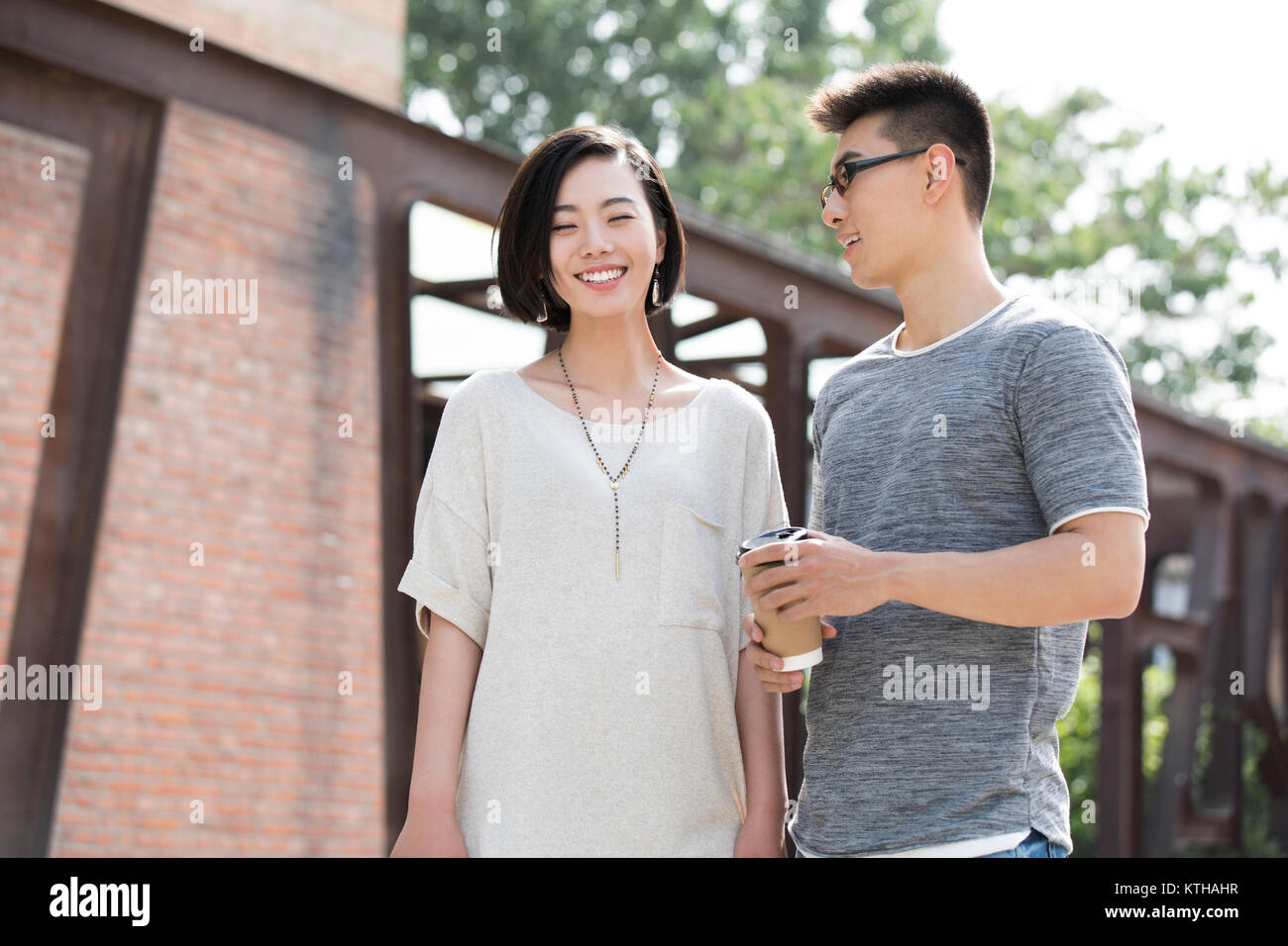Young couple talking outdoors Stock Photo - Alamy
