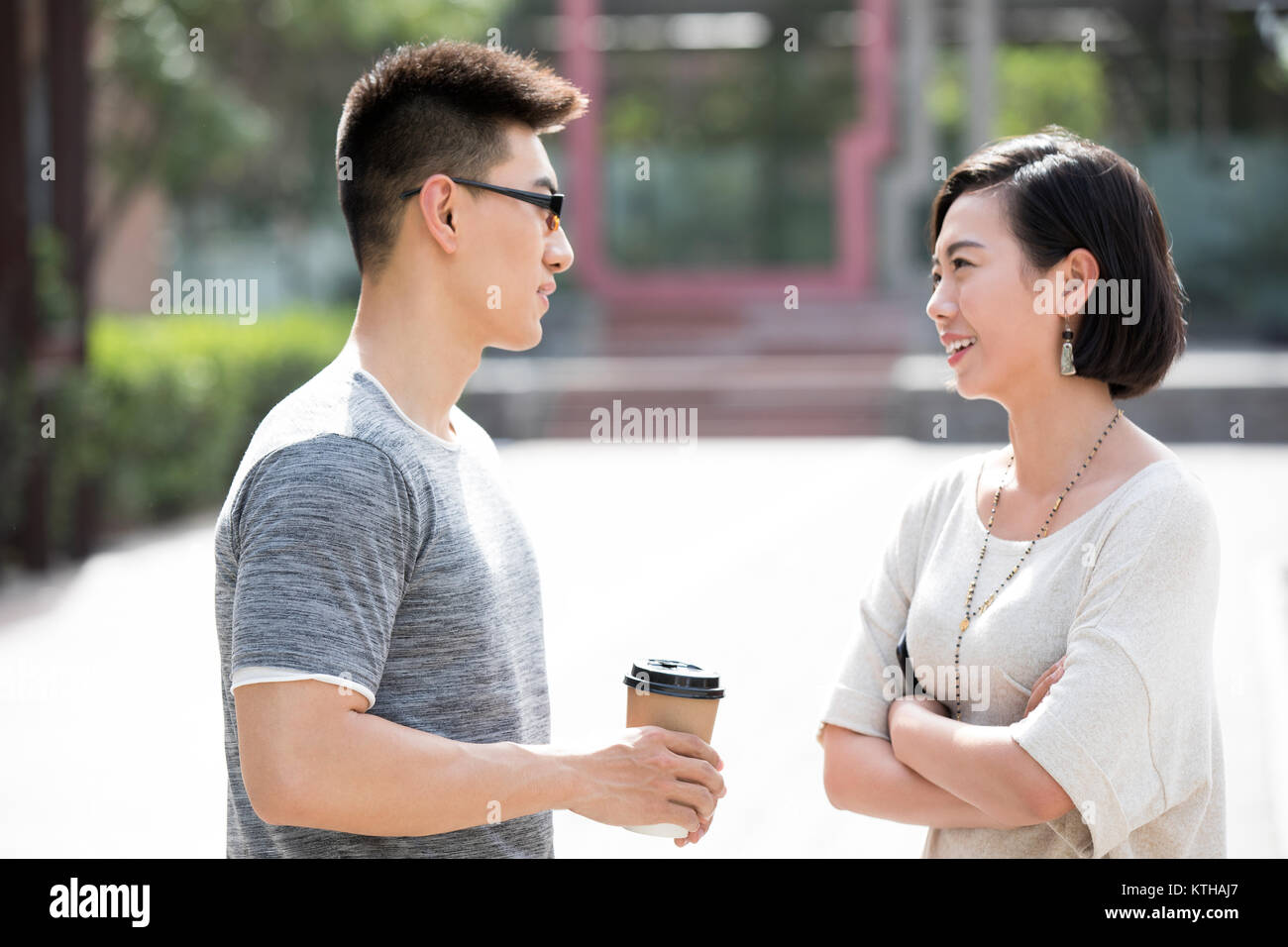 Young couple talking outdoors Stock Photo - Alamy