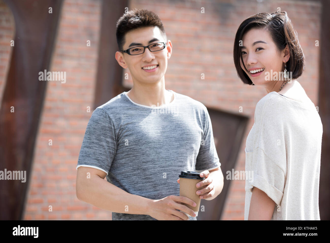 Young couple talking outdoors Stock Photo - Alamy
