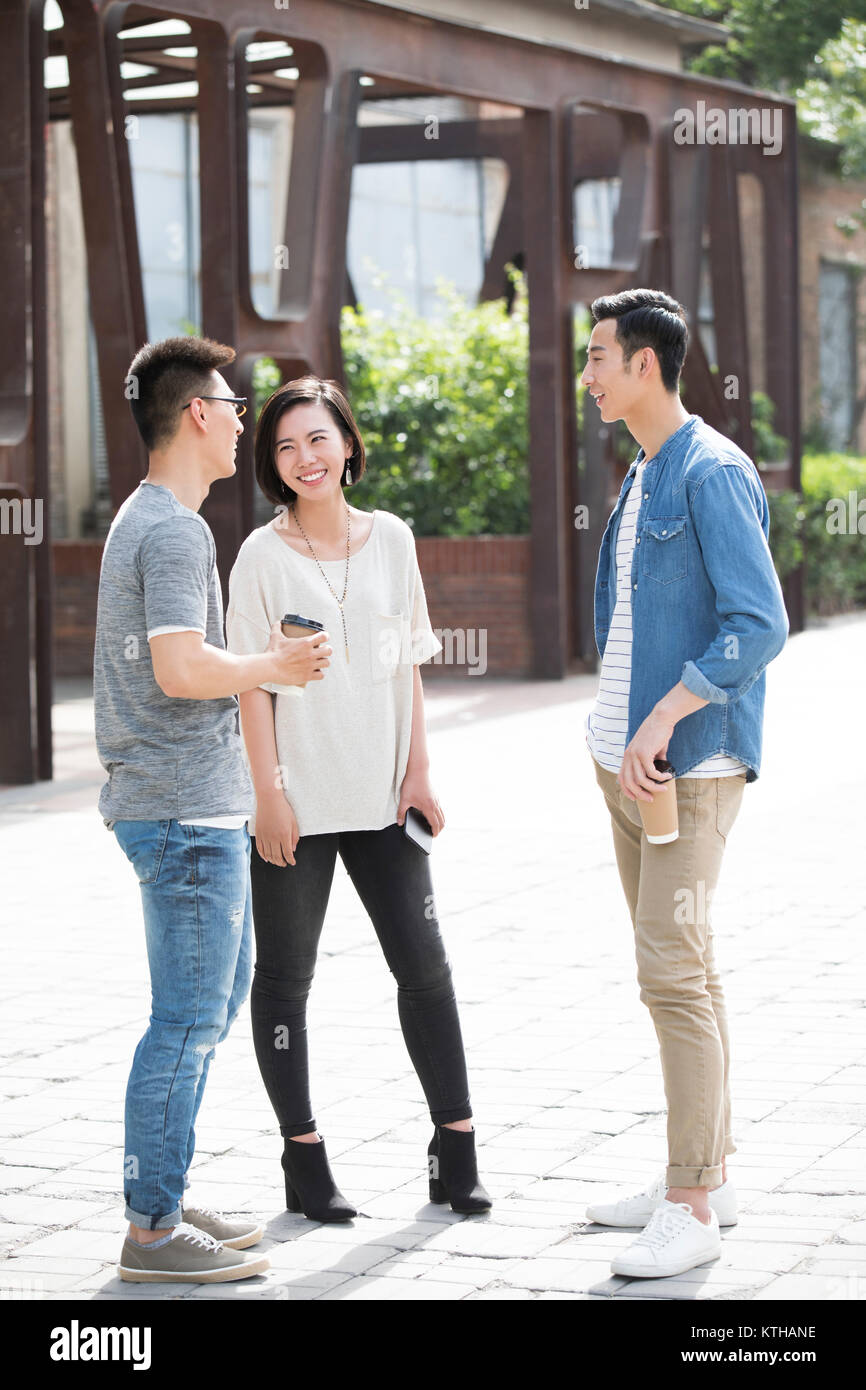 Cheerful young friends talking outdoors Stock Photo - Alamy