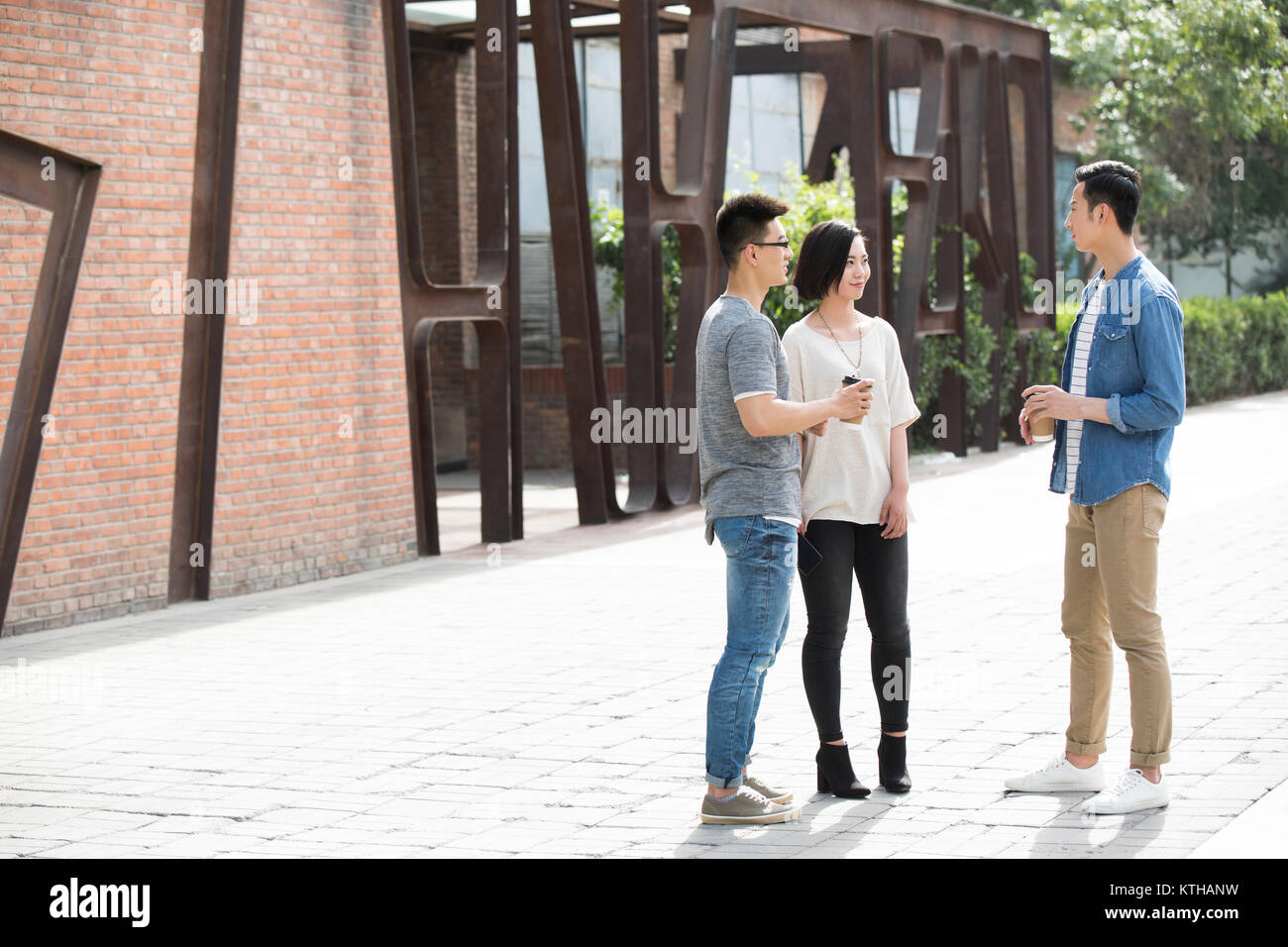Cheerful young friends talking outdoors Stock Photo - Alamy