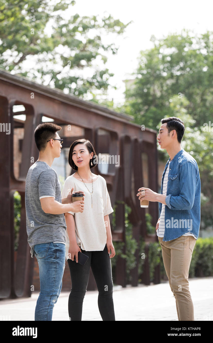 Cheerful young friends talking outdoors Stock Photo - Alamy