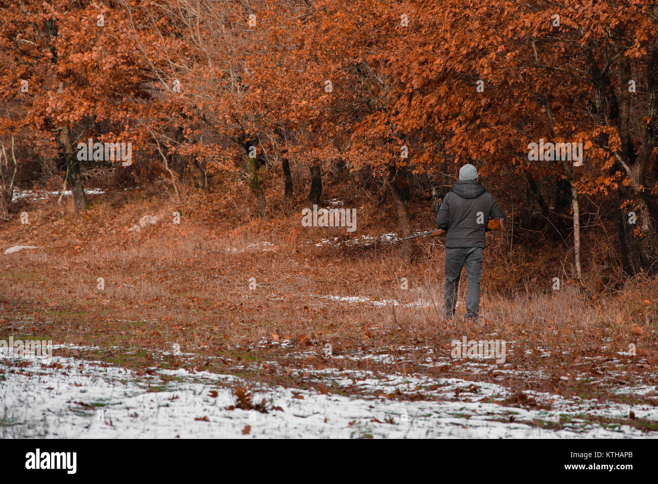 Hunter man with rifle in the forest. Authentic lifestyle Stock Photo ...