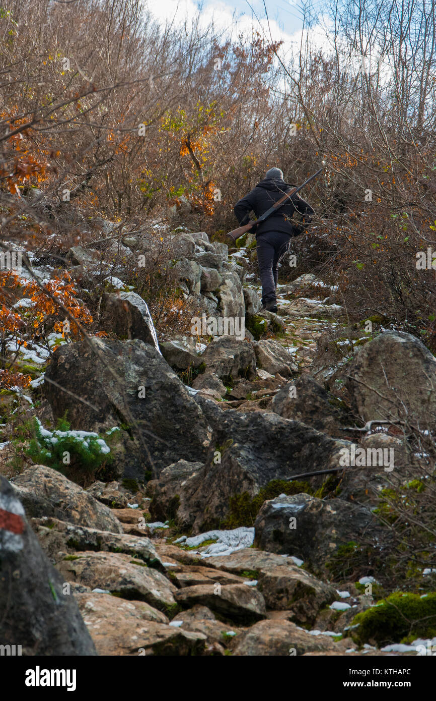 Hunter man with rifle in the forest. Authentic lifestyle Stock Photo ...