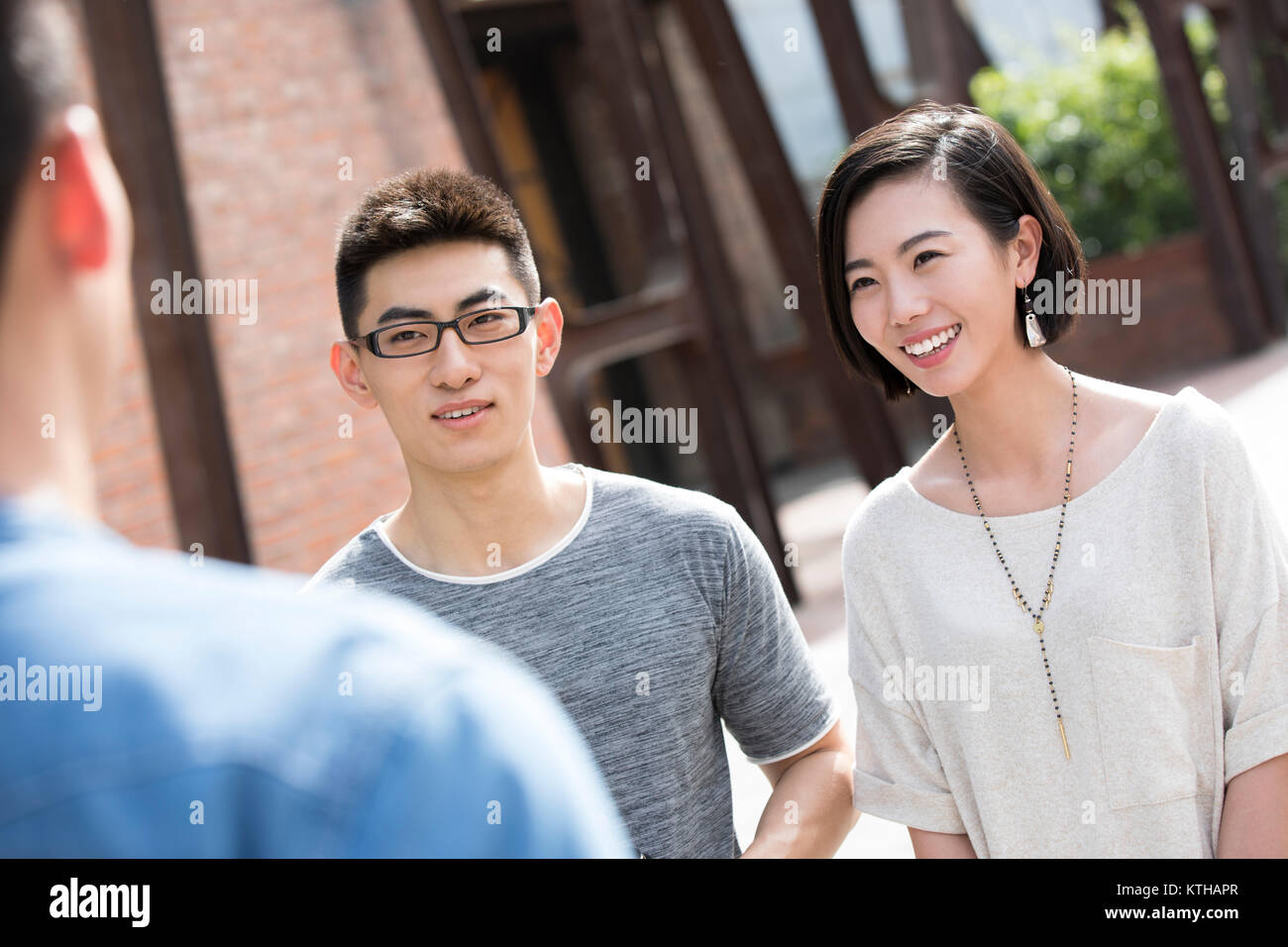 Cheerful young friends talking outdoors Stock Photo - Alamy