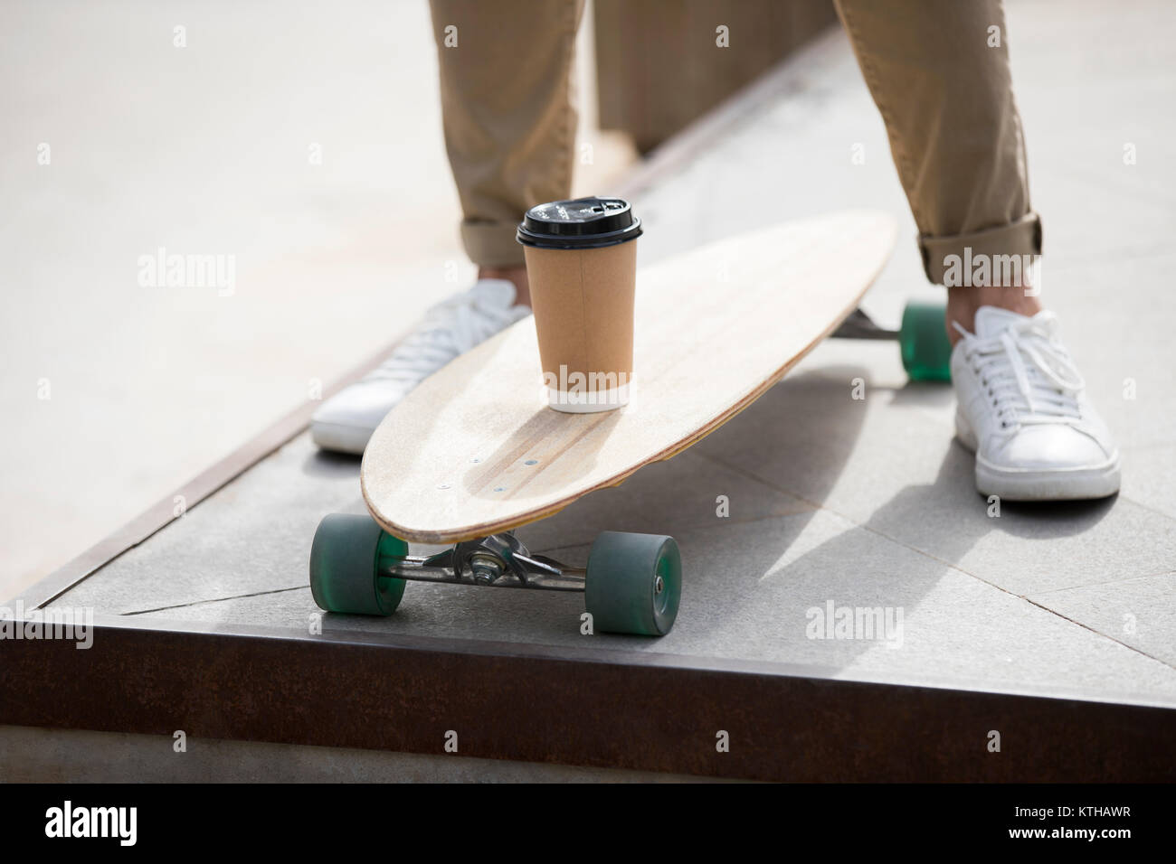 A cup of coffee on the skateboard Stock Photo - Alamy