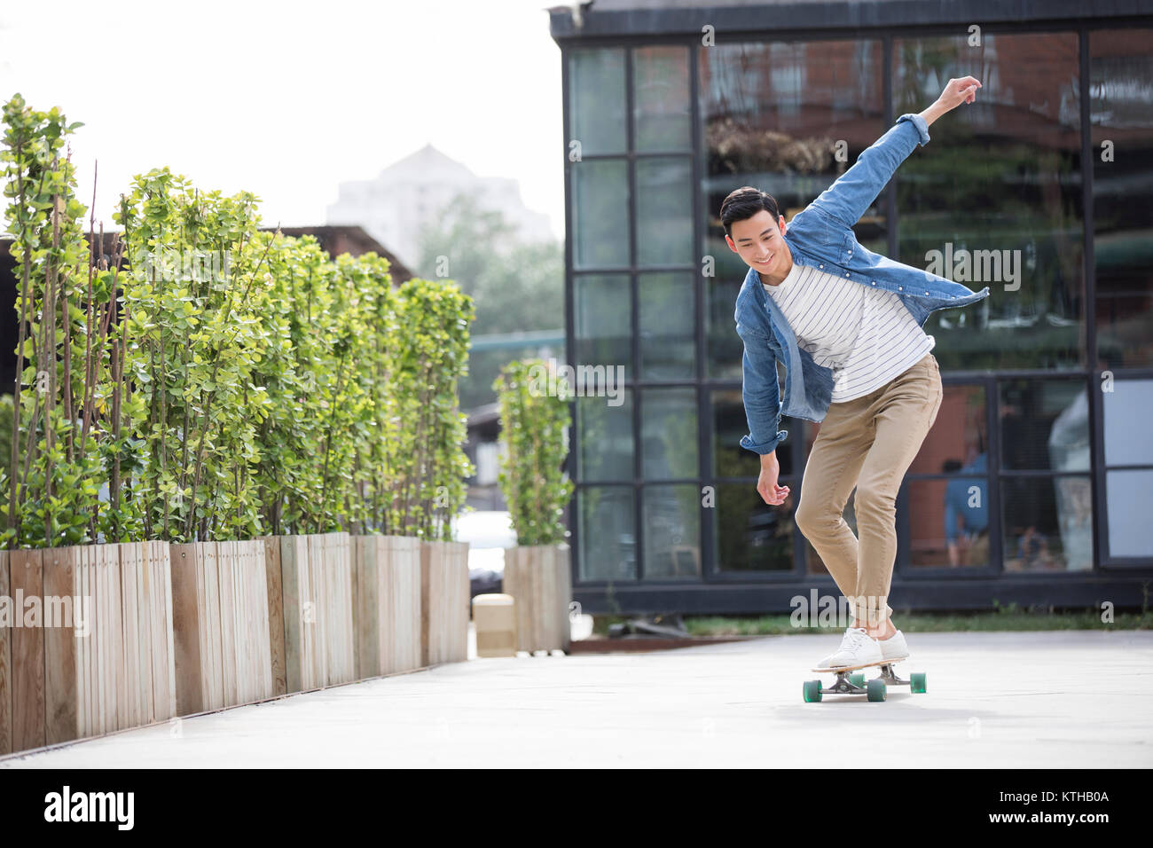 Cheerful young man skateboarding Stock Photo - Alamy