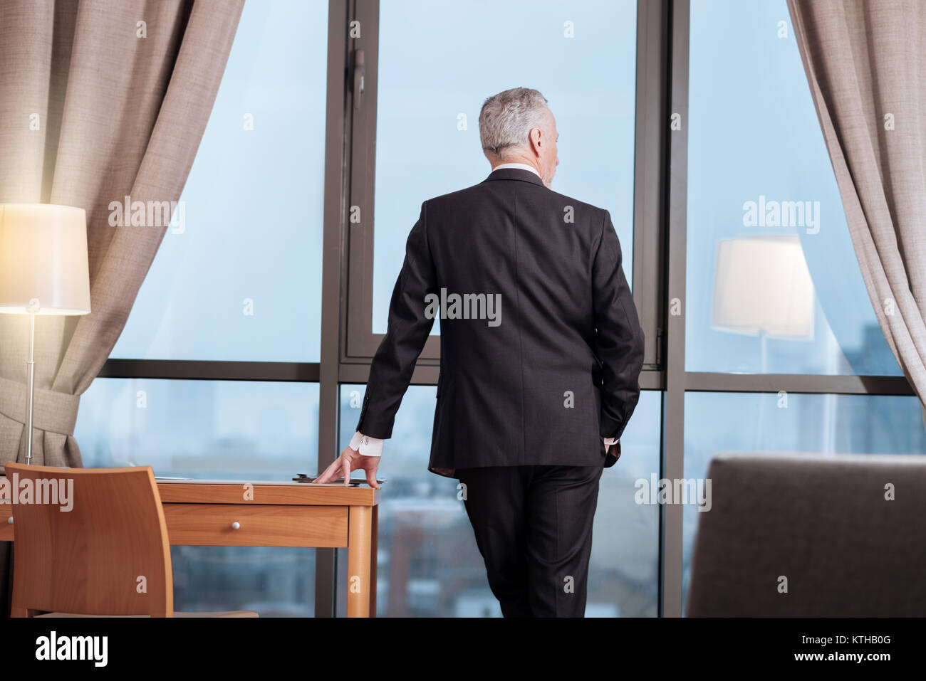 Senior experienced businessman esteeming view Stock Photo - Alamy