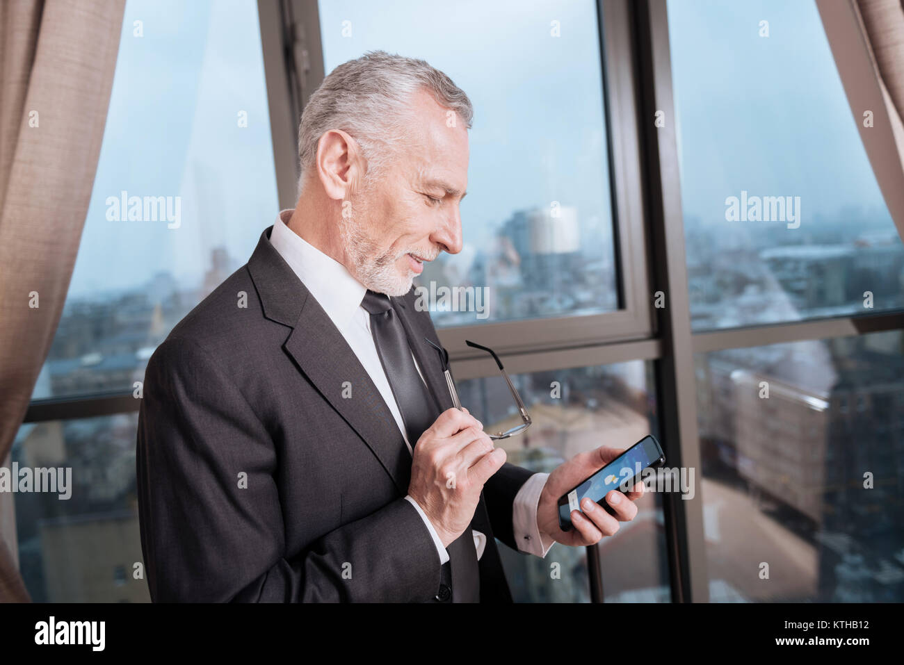 Attractive senior man checking his messages Stock Photo - Alamy