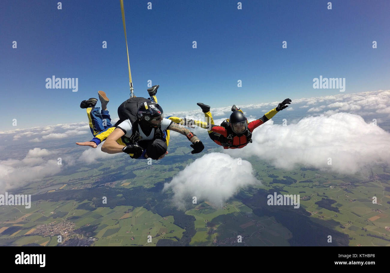 This tandem skydiving couple, plus the fun jumper are enjoying the ...