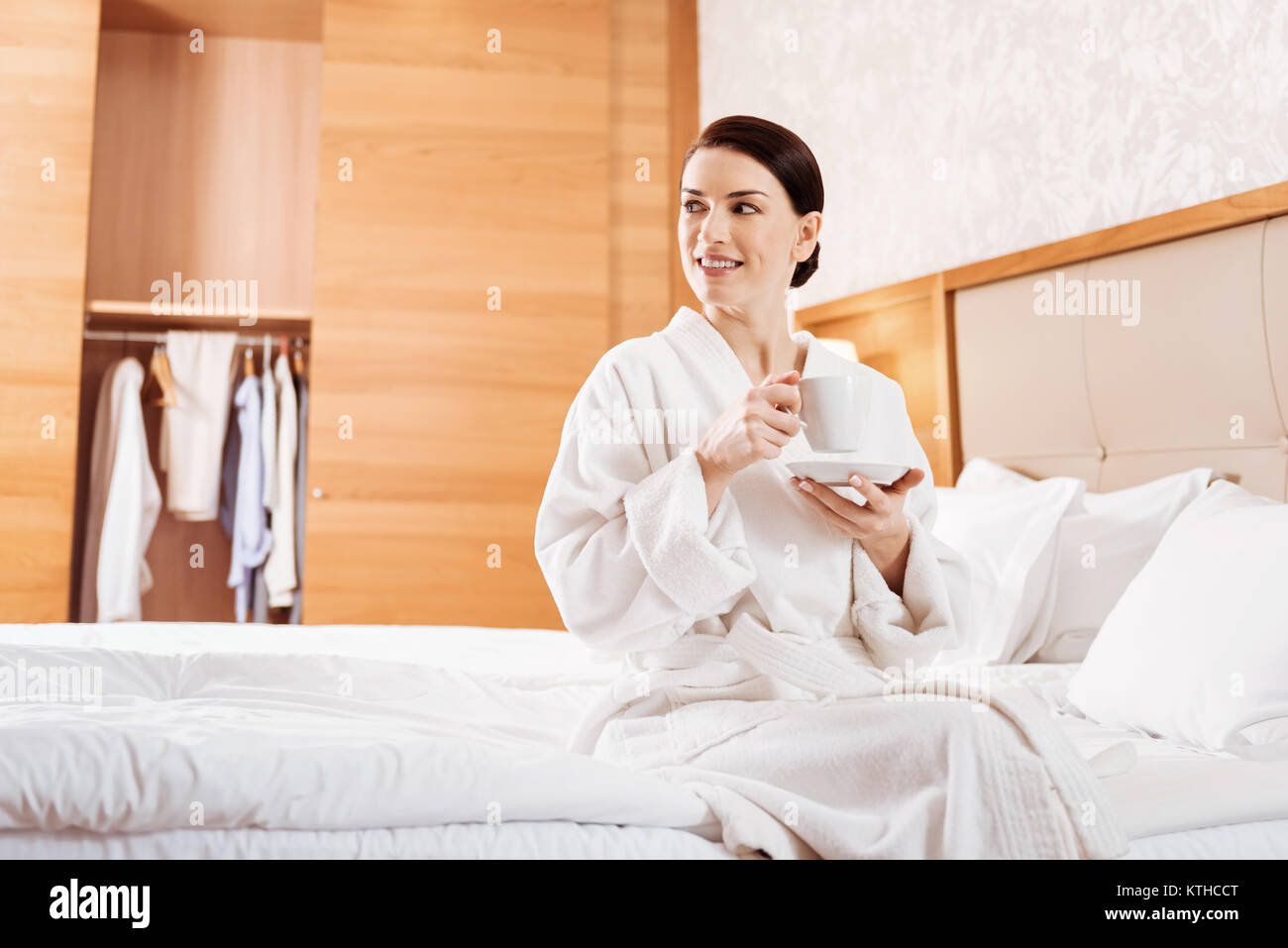 Positive cunning woman holding cup of tea Stock Photo - Alamy