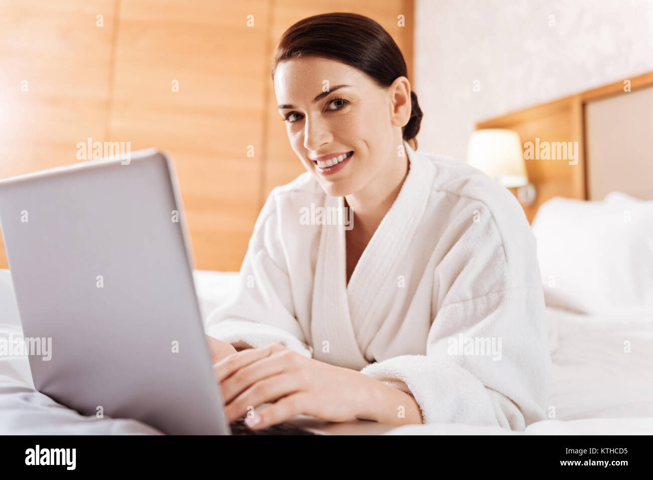 Glad joyful woman typing letter Stock Photo - Alamy