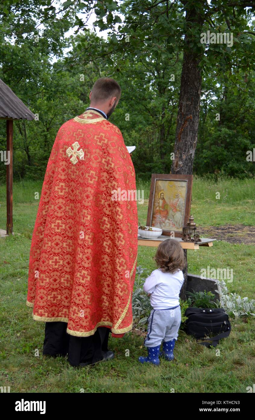 priest and a little boy Stock Photo - Alamy