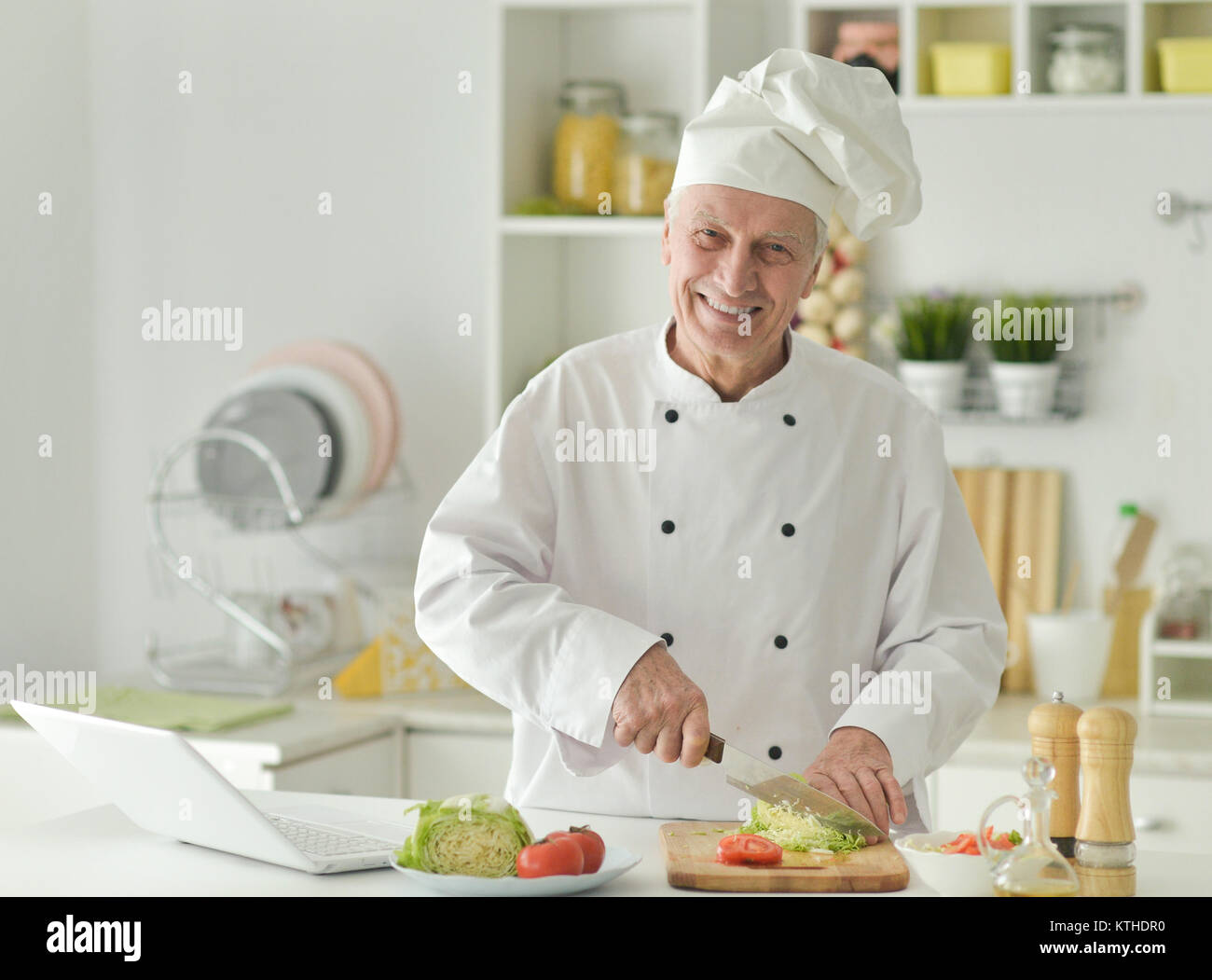 Portrait of a elderly male chef cooking salad Stock Photo - Alamy