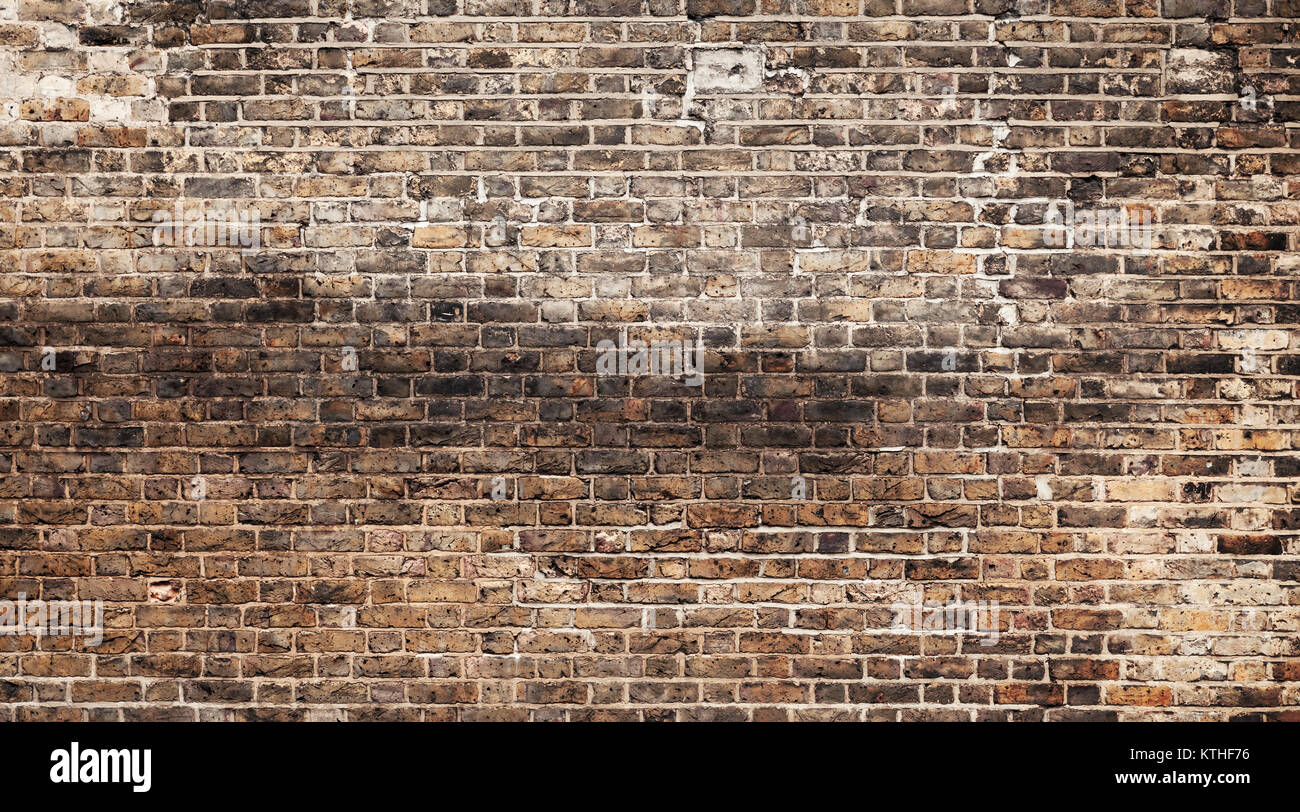 Old grungy dark brick wall, background photo texture Stock Photo - Alamy