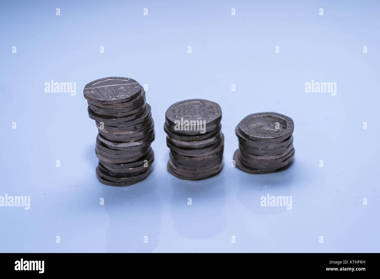 Stacks of different British coins on a white background Stock Photo - Alamy