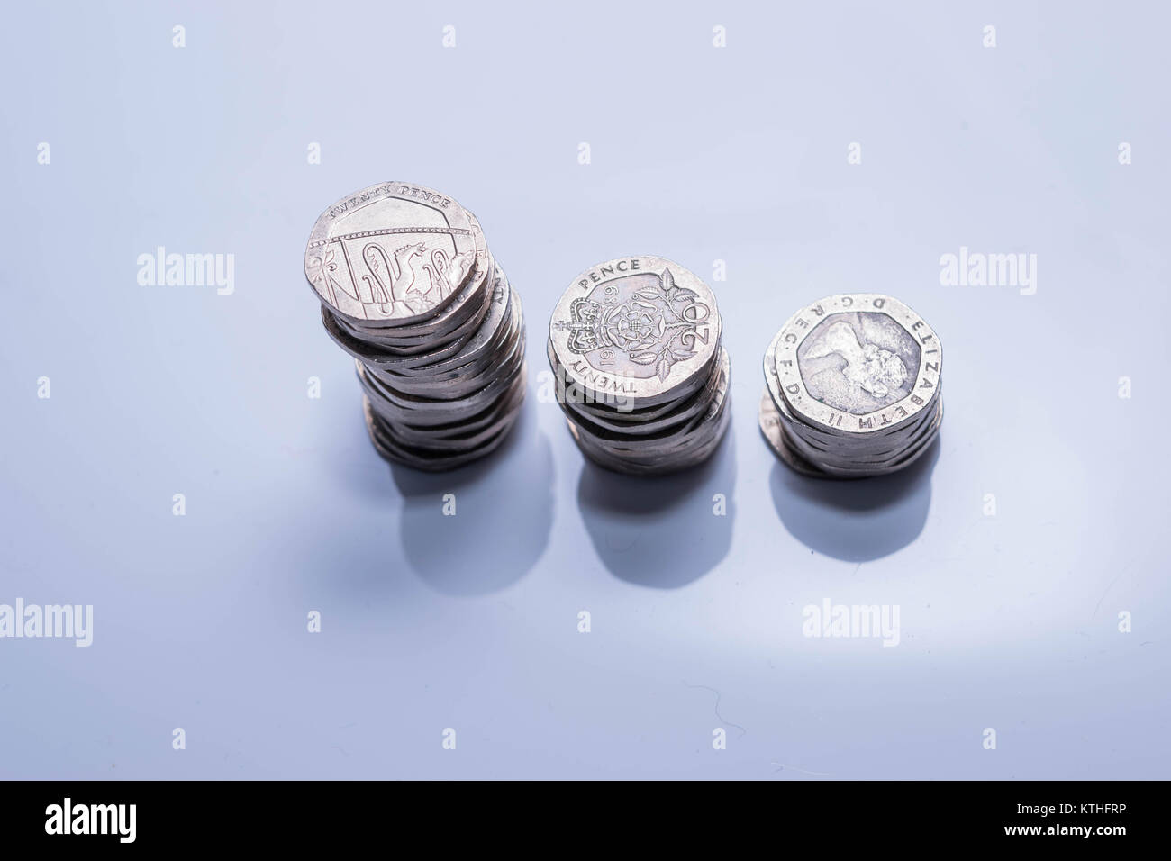 Stacks of different British coins on a white background Stock Photo - Alamy