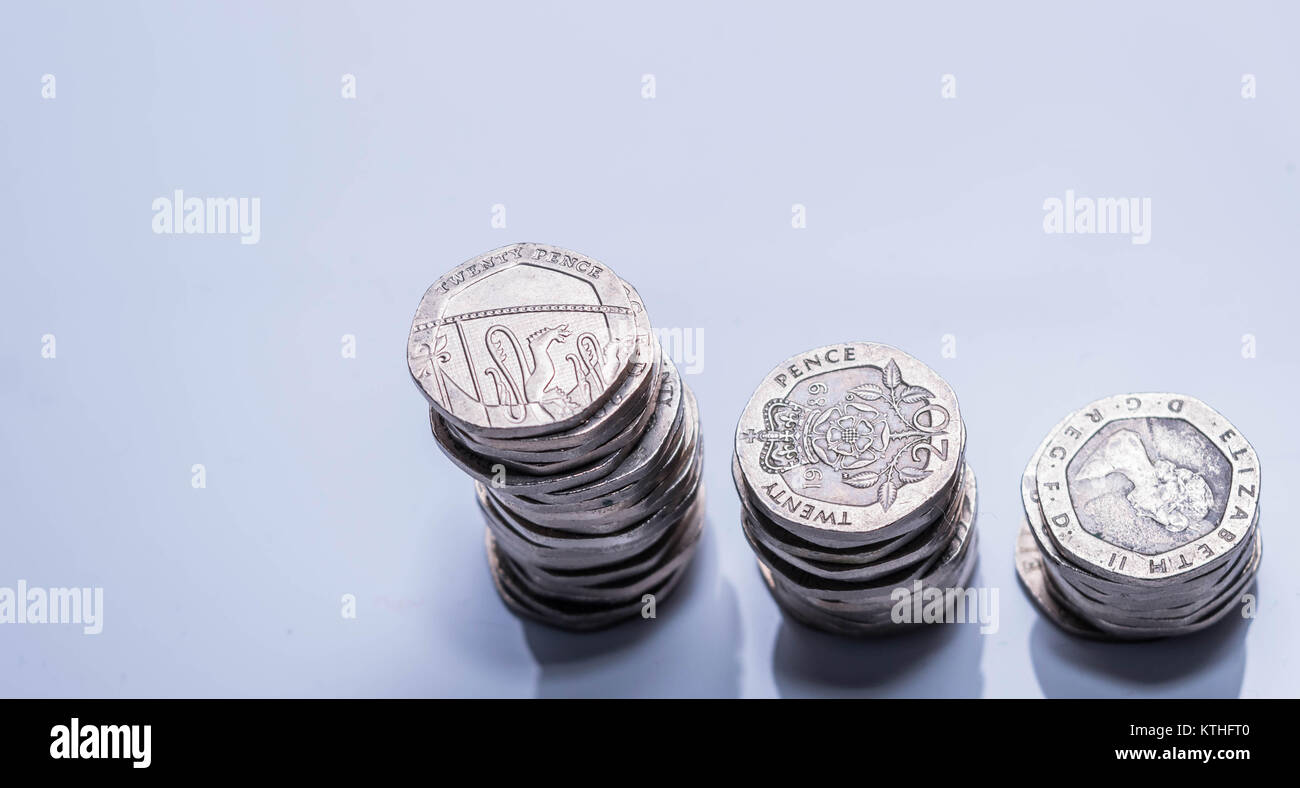 Stacks of different British coins on a white background Stock Photo - Alamy