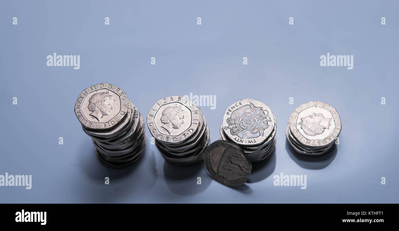 Stacks of different British coins on a white background Stock Photo - Alamy
