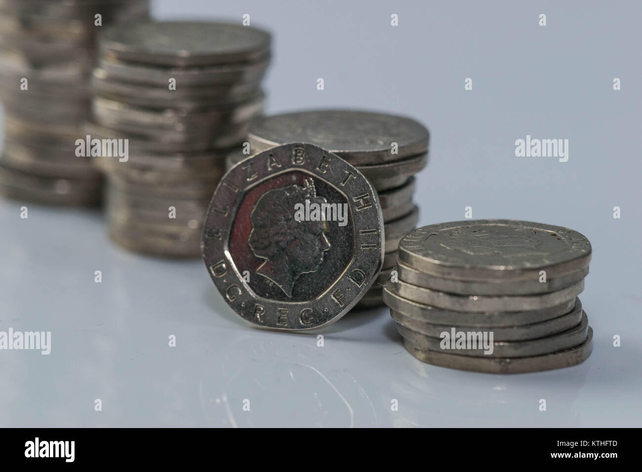 Stacks of different British coins on a white background Stock Photo - Alamy