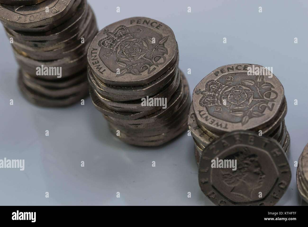 Stacks of different British coins on a white background Stock Photo - Alamy