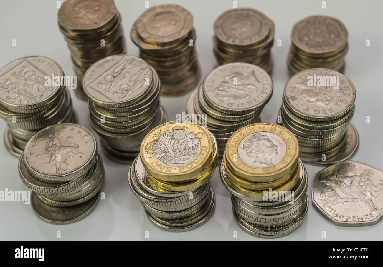 Stacks of different British coins on a white background Stock Photo - Alamy