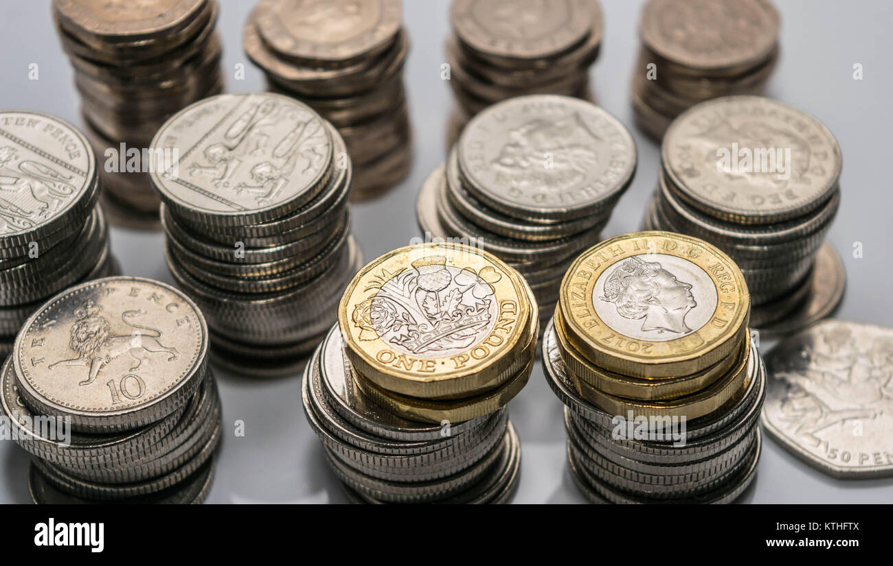 Stacks of different British coins on a white background Stock Photo - Alamy