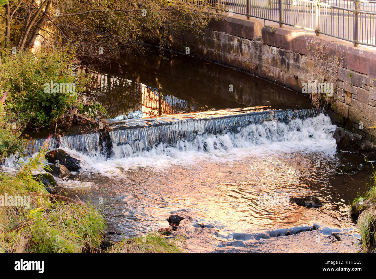 Urban watercourse, stream through a town Stock Photo - Alamy
