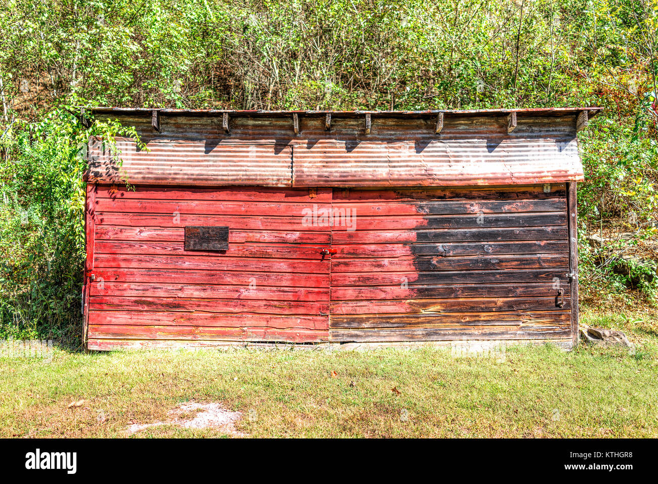 Abandoned retro vintage red barn shed exterior with locked doors and ...