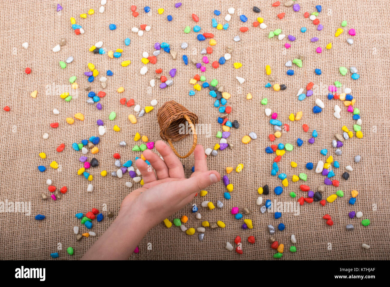 Bucket of colorful pebbles spill on background Stock Photo - Alamy