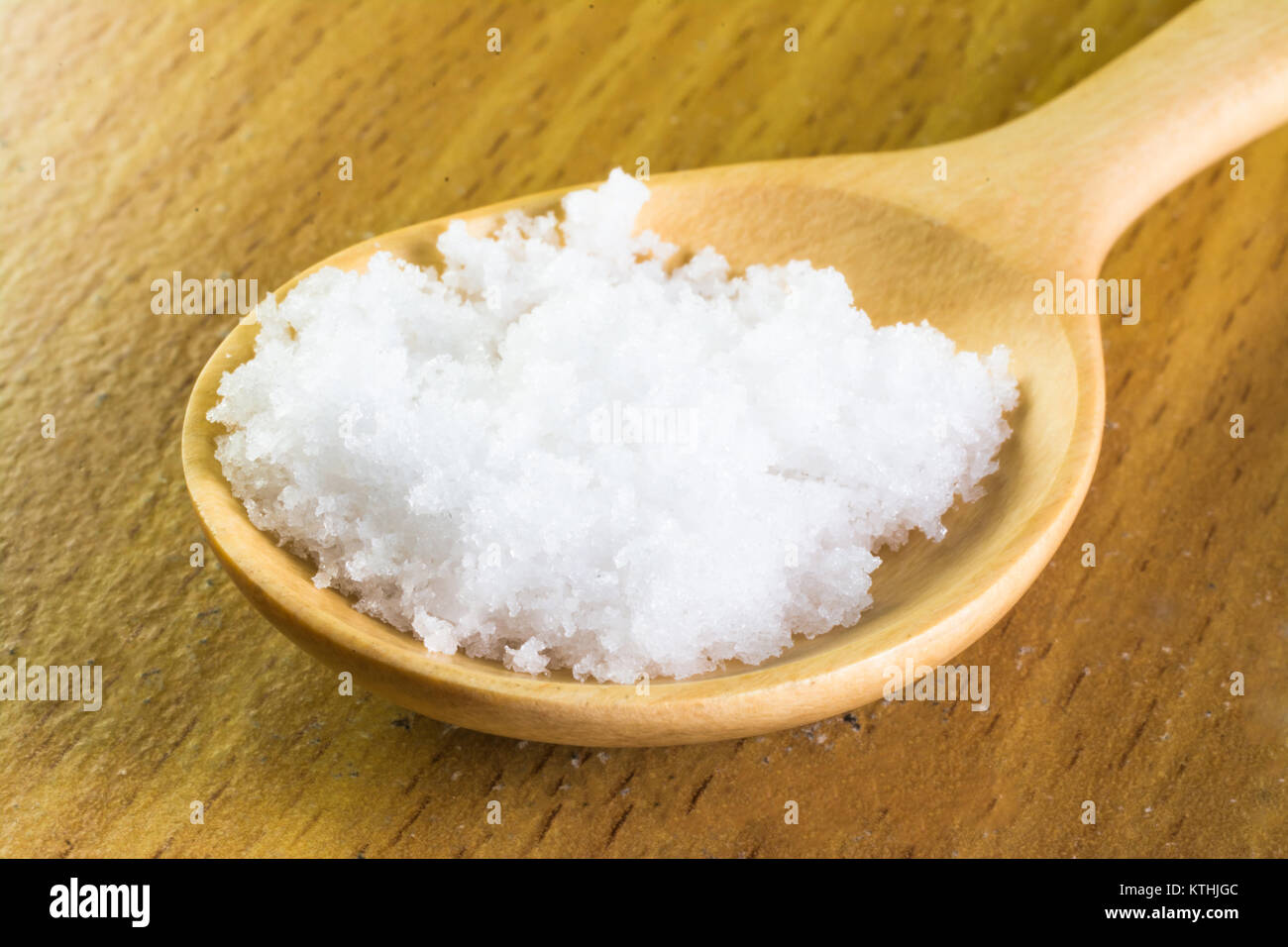 Salt in wooden spoon Stock Photo - Alamy