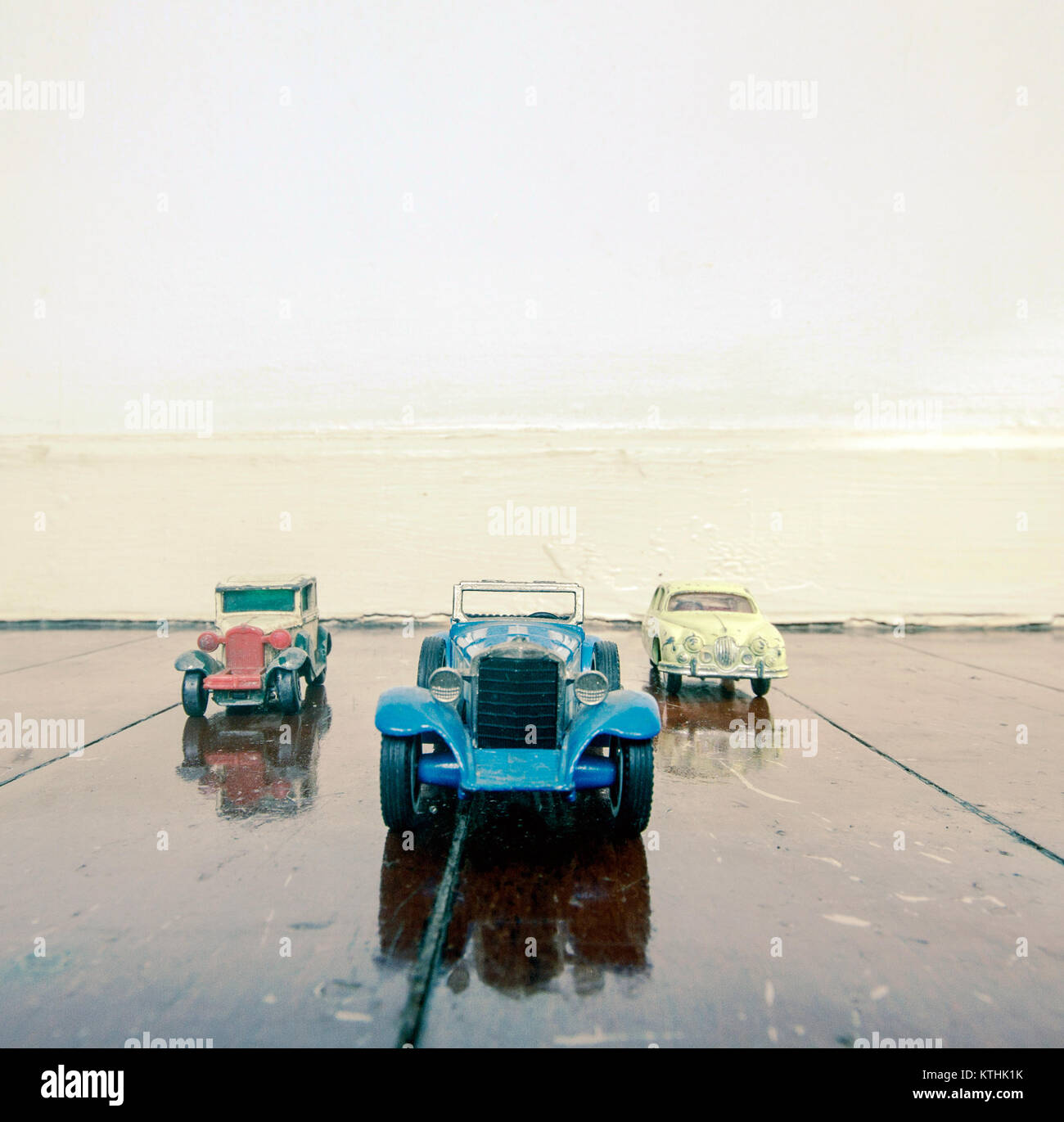 three vintage toy cars on a wooden floor with reflection Stock Photo ...