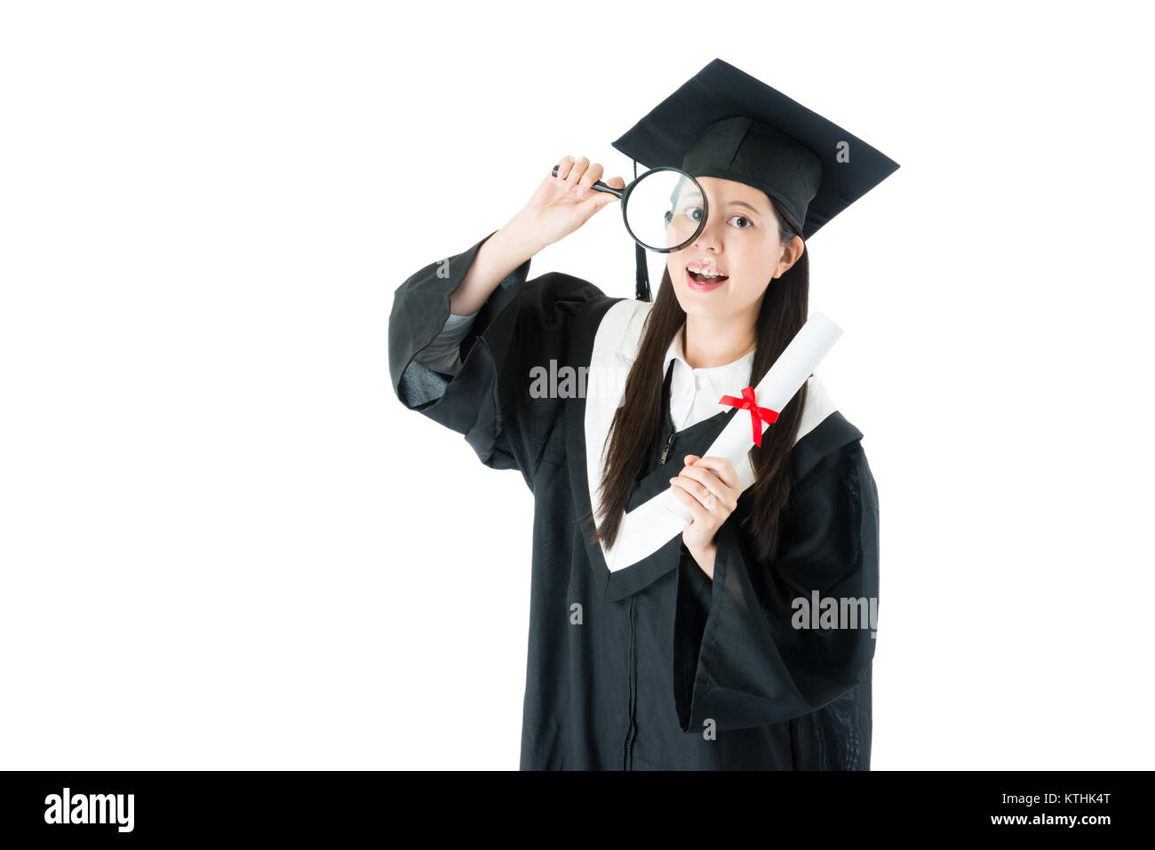 happy beautiful female graduate holding magnifier looking at camera ...