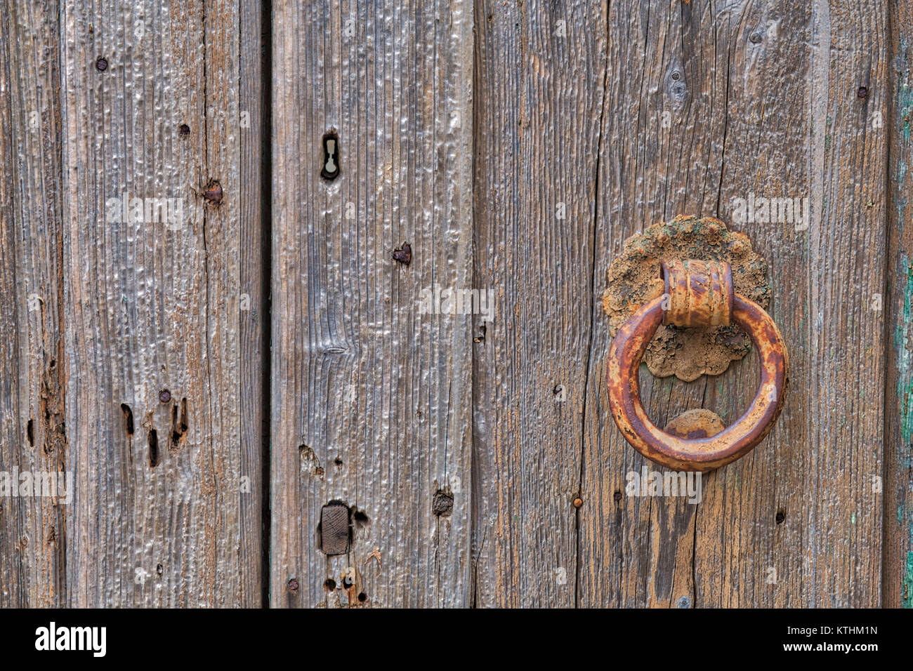 Rusted iron ring handle on peeling and eaten old wooden door Stock ...