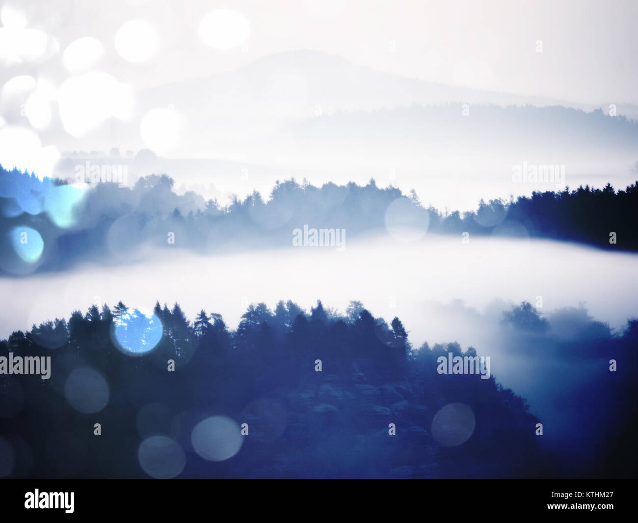 Abstract effect. Autumn sunrise in mountain within inversion. Peaks of ...