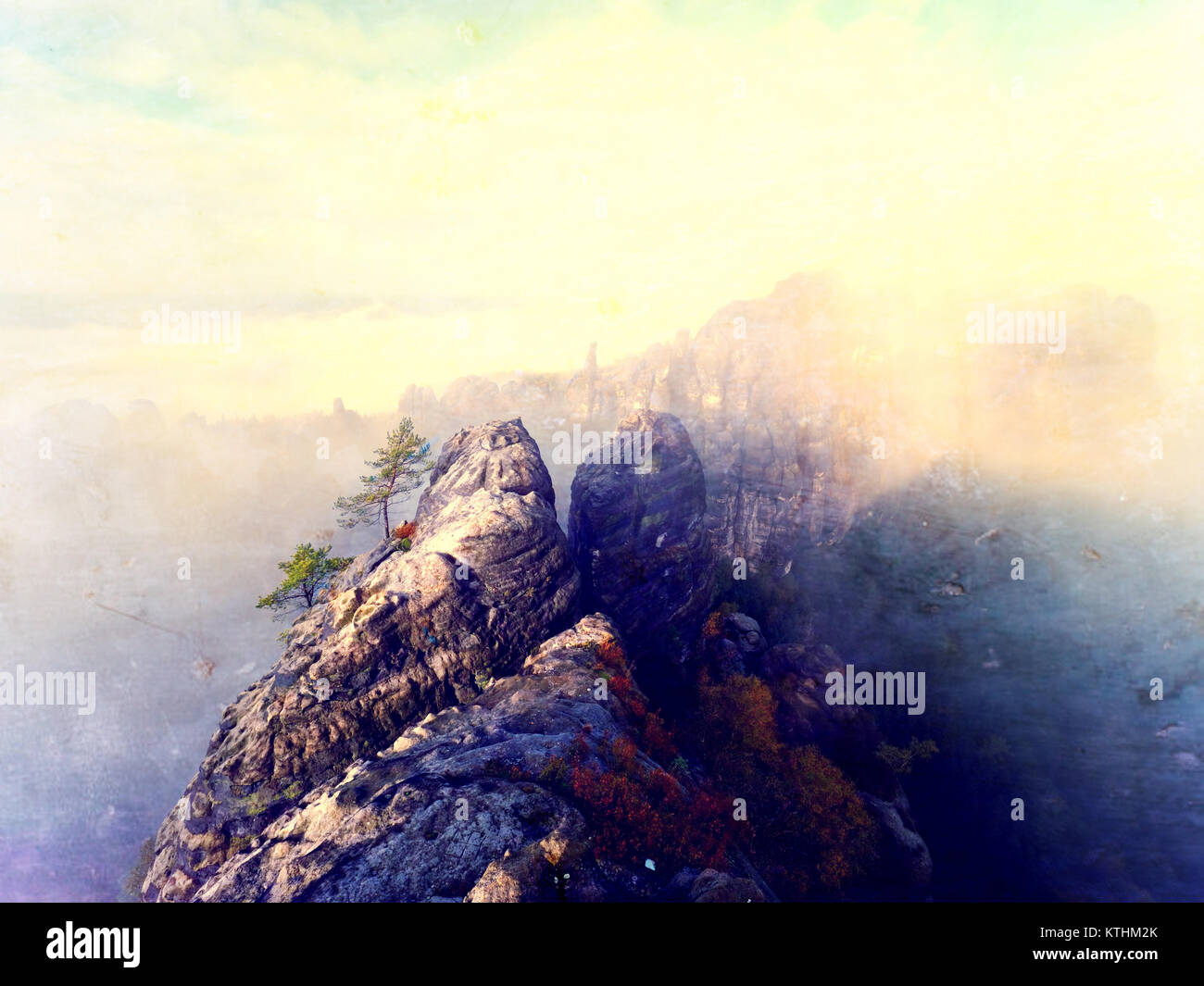 Abstract effect. Autumn sunrise in mountain within inversion. Peaks of ...
